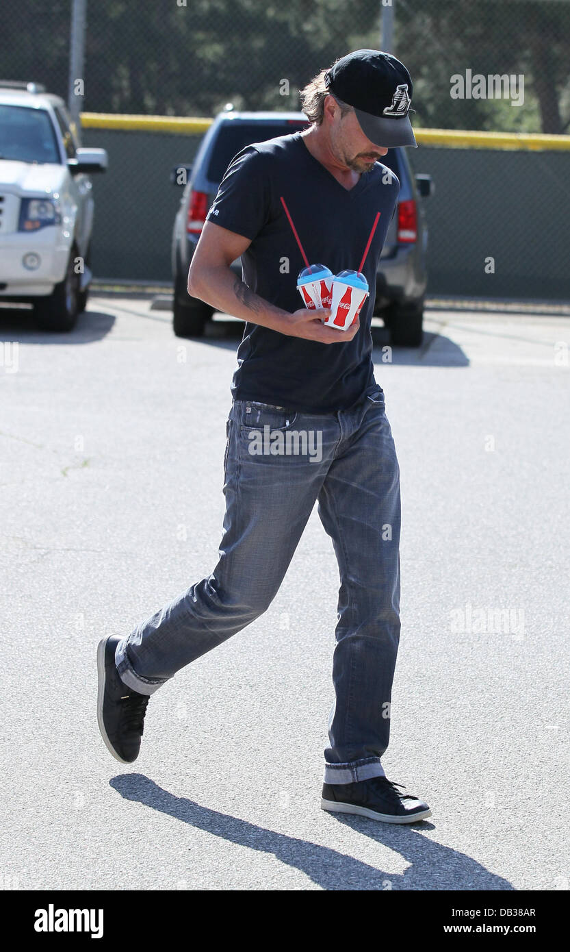 Jason Trawick returns to his car with some refreshments for himself and ...