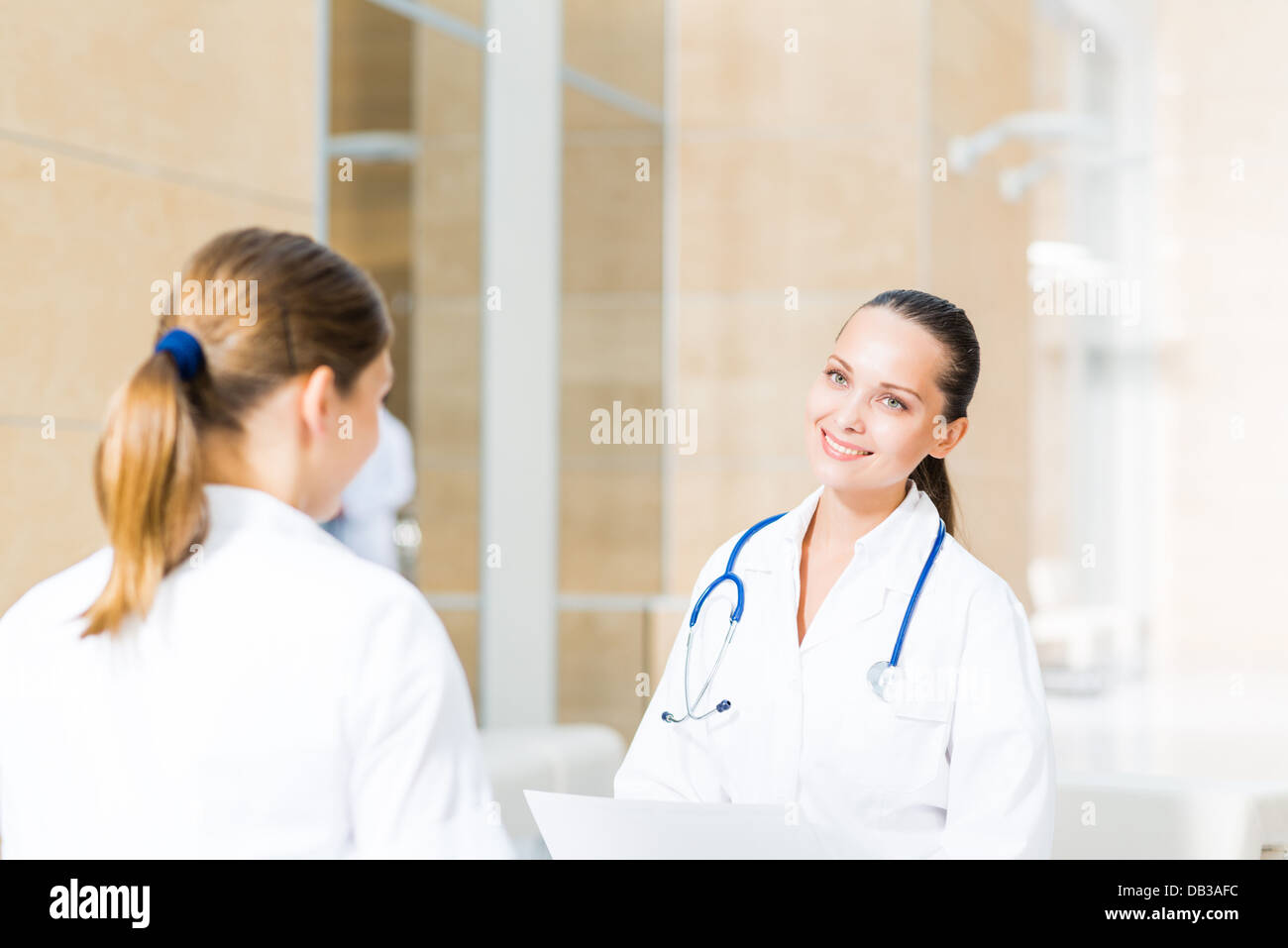 two doctors talking in the lobby of the hospital Stock Photo - Alamy