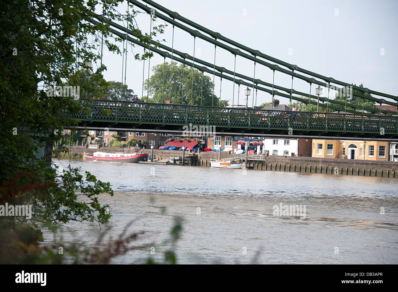 View of Hammersmith suspension Bridge over the river Thames in London ...