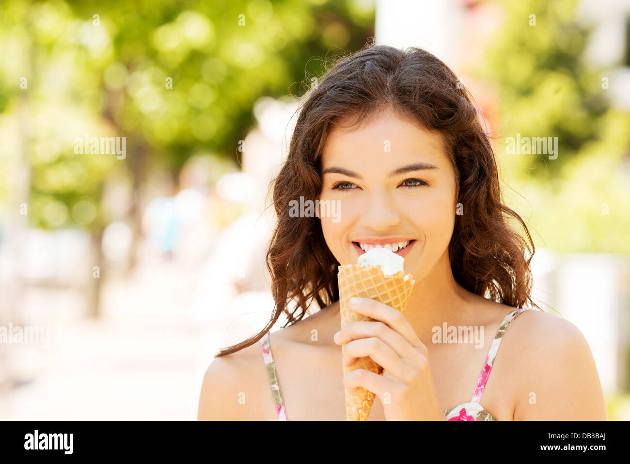Portrait of young happy woman eating ice-cream, outdoor Stock Photo - Alamy