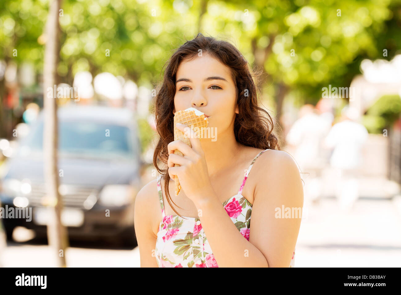 Portrait of young happy woman eating ice-cream, outdoor Stock Photo - Alamy