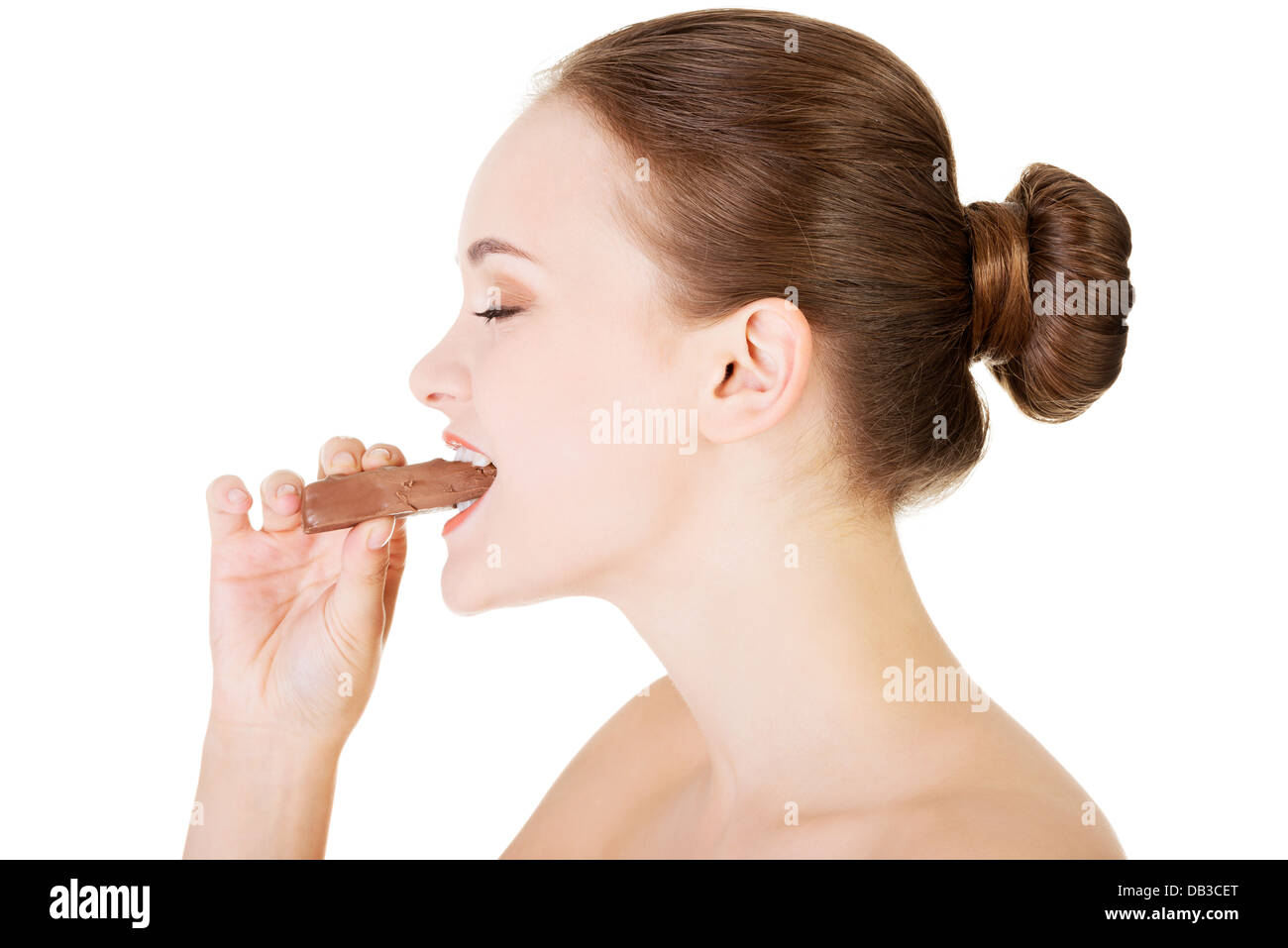 Beautiful woman biting a chocolate bar. Isolated on white Stock Photo ...