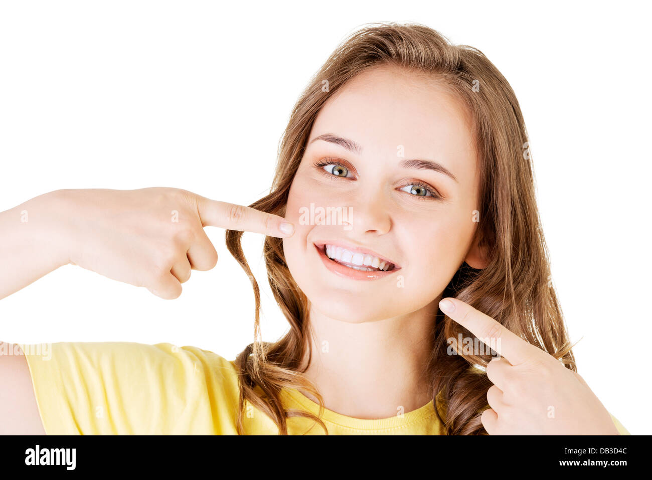 Teen girl pointing on her perfect teeth, isolated on white Stock Photo ...