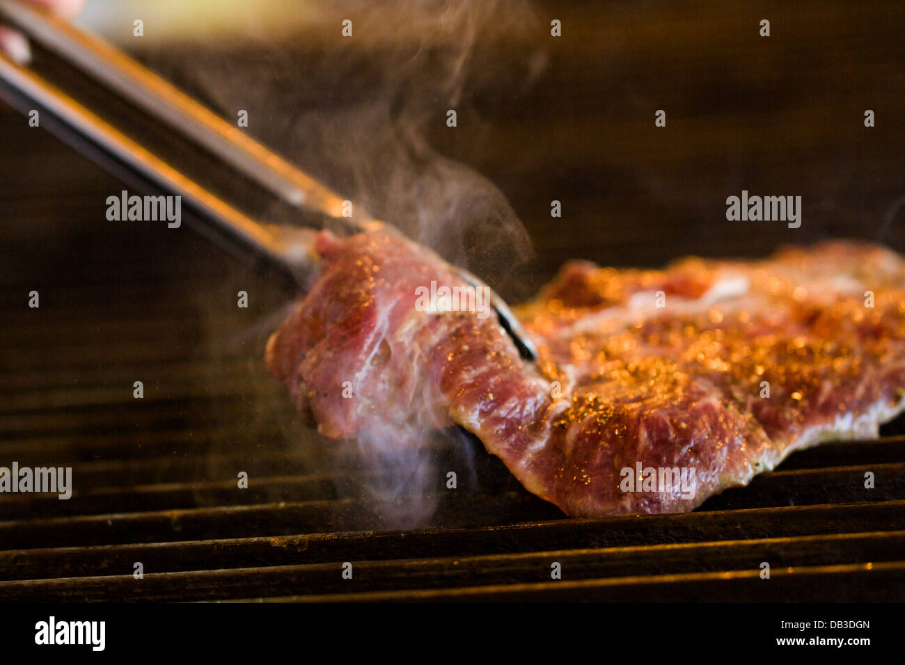 Slice of beef on barbecue grill Stock Photo - Alamy