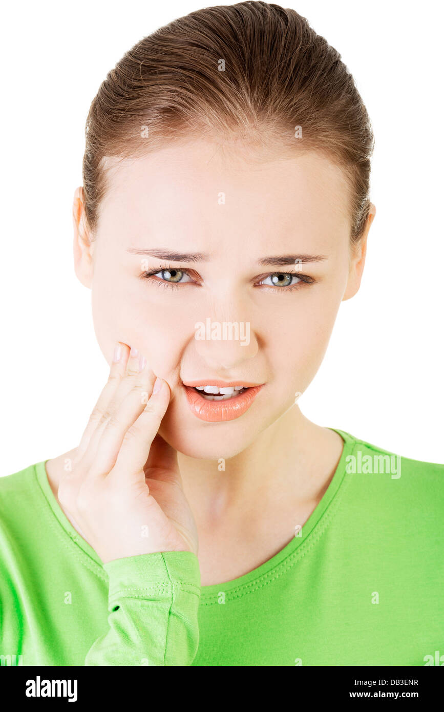 Teen woman pressing her bruised cheek with a painful expression as if ...