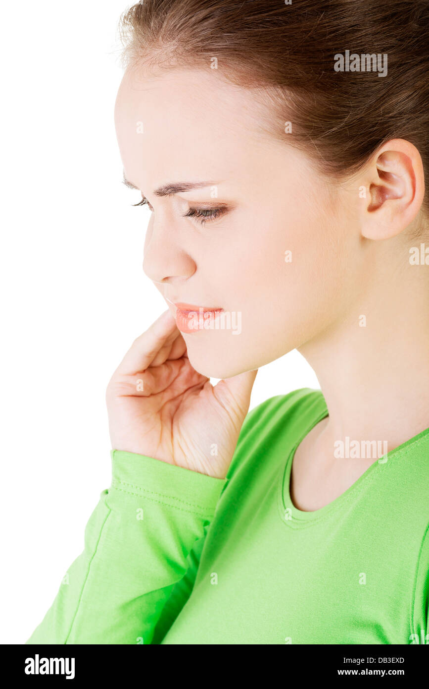 Teen woman pressing her bruised cheek with a painful expression as if ...
