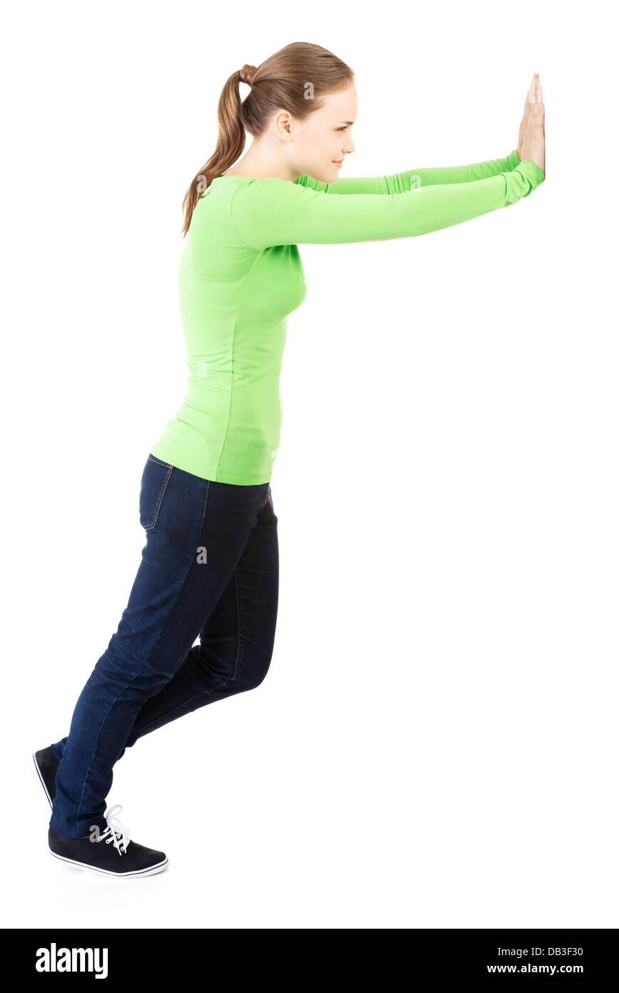 Woman pushing something imaginary isolated over a white background ...