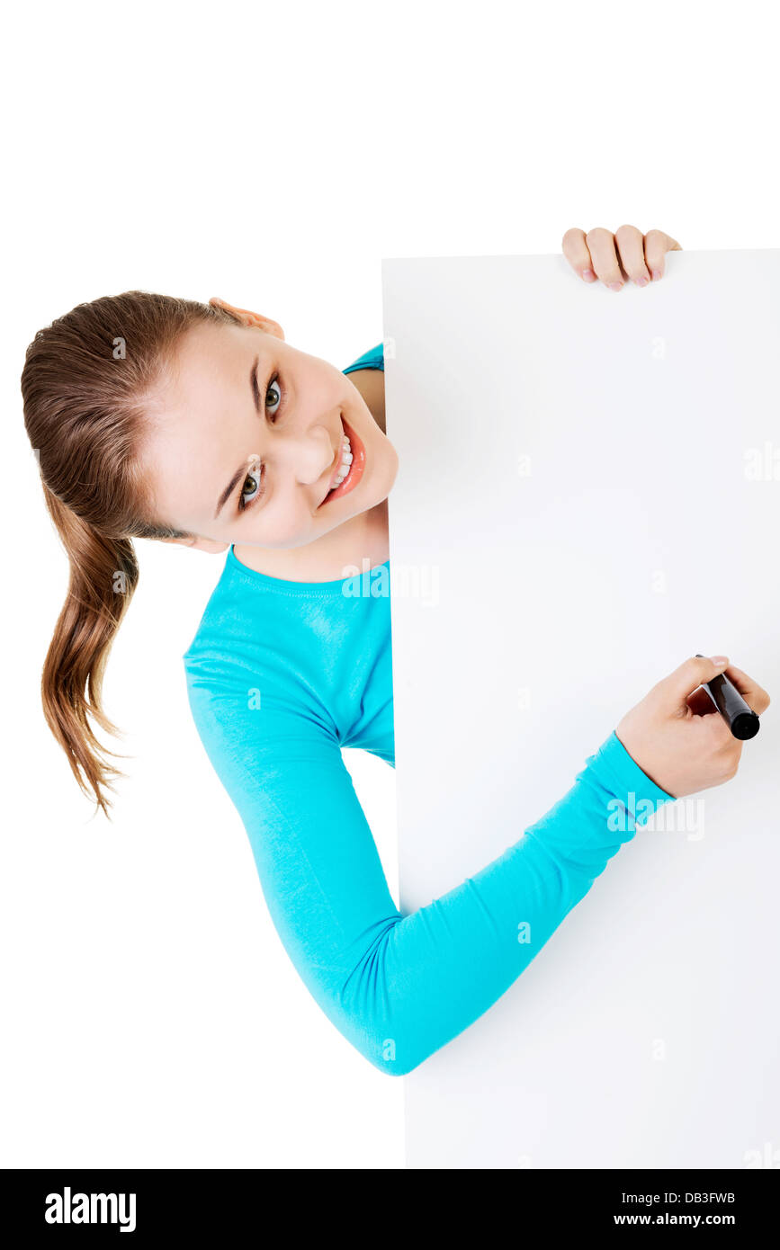 Happy beautiful woman writing with a pen on blank board. Student or ...
