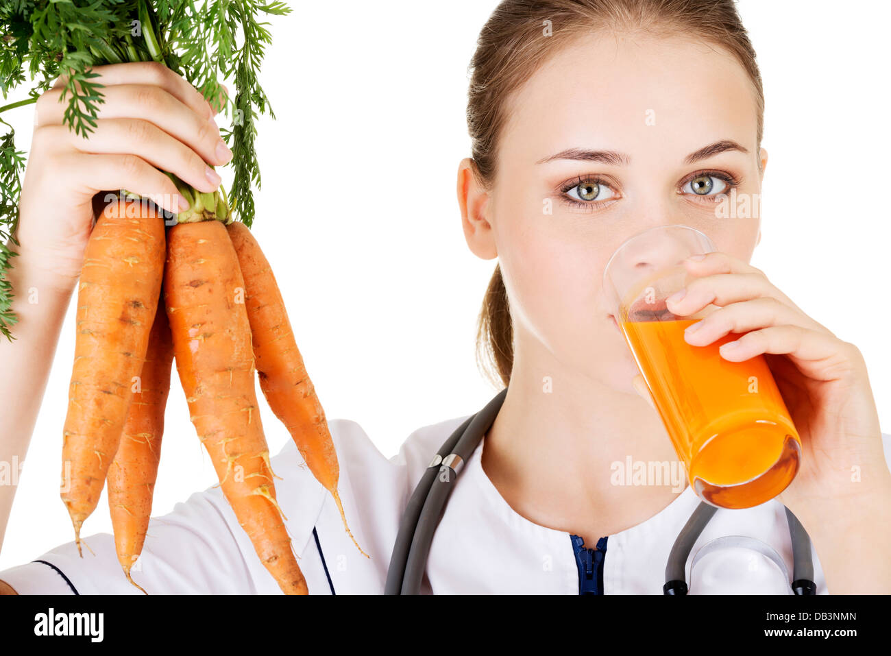 Female doctor holding healthy carrots and juice. Isolated on white ...