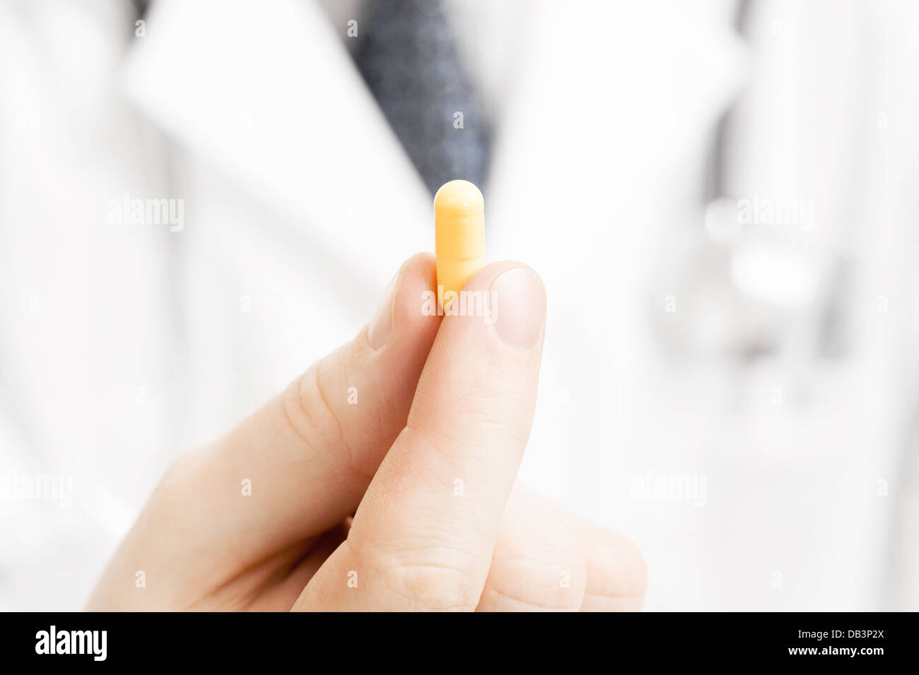 Medical doctor holding one pill with two fingers of right hand Stock ...