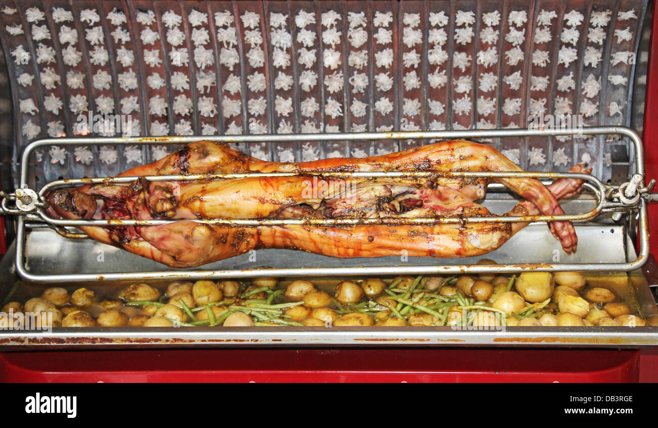 Young delicious suckling pig roasted on a spit Stock Photo - Alamy