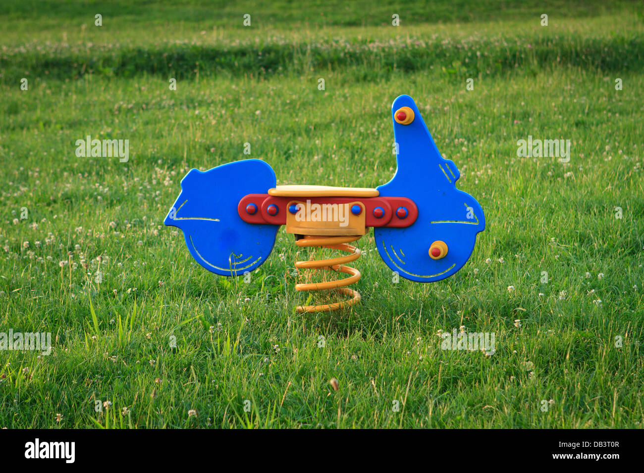 Bike spring rider - toy for children on a mountain meadow Stock Photo ...