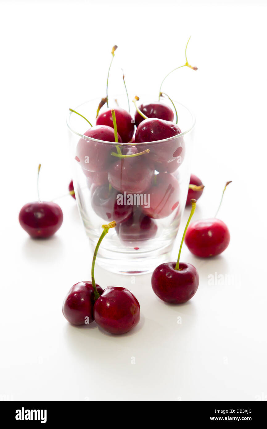 Cherry in a glass container isolated on white Stock Photo - Alamy