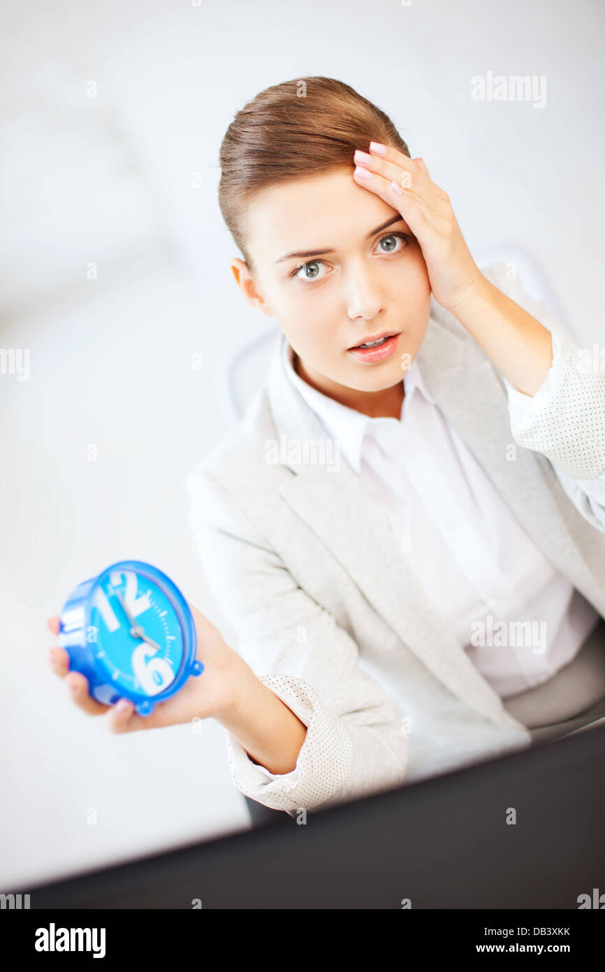 stressed businesswoman holding clock Stock Photo - Alamy
