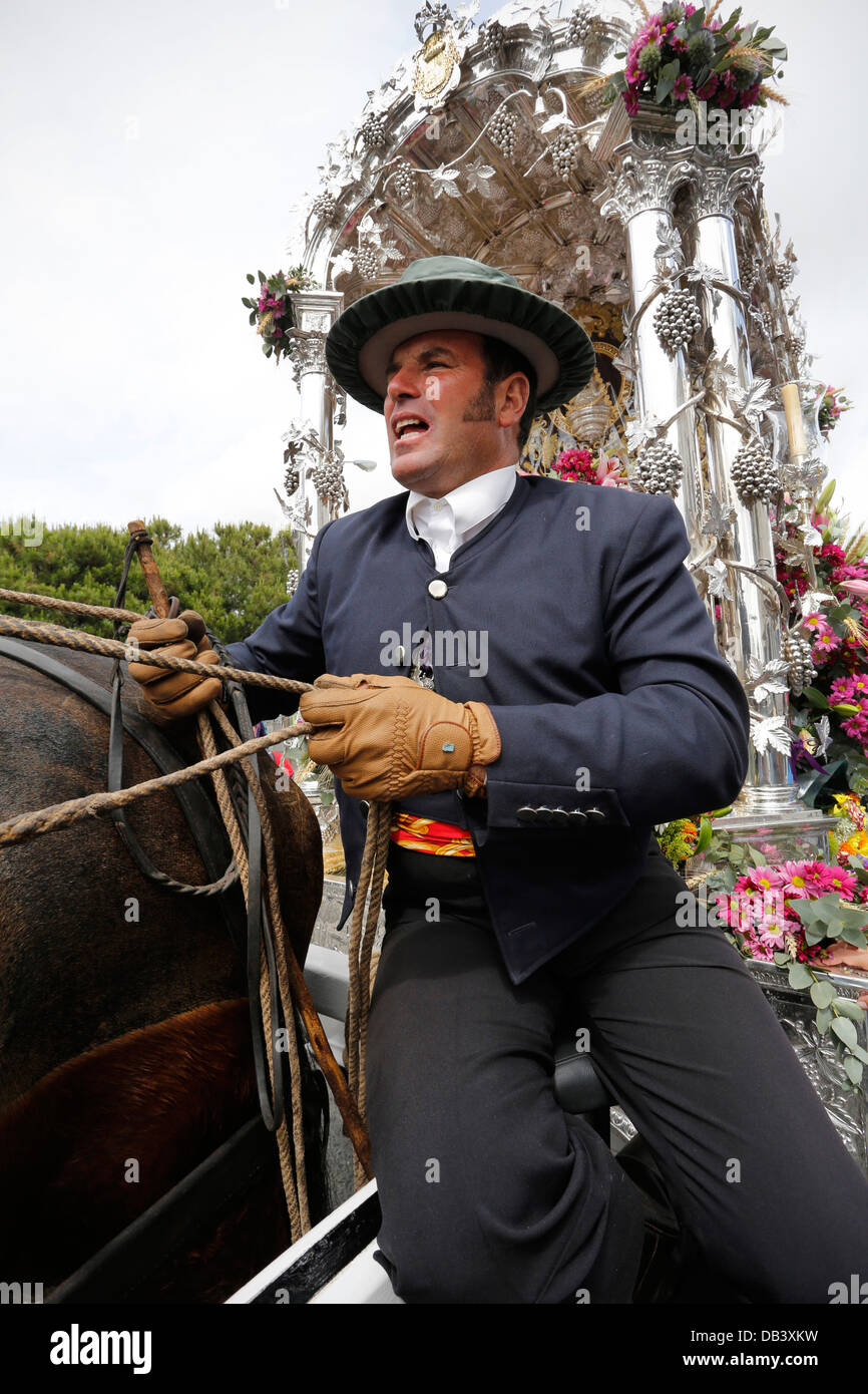 Man dressed in Andalusian style steering the altar carrying Virgin Mary ...