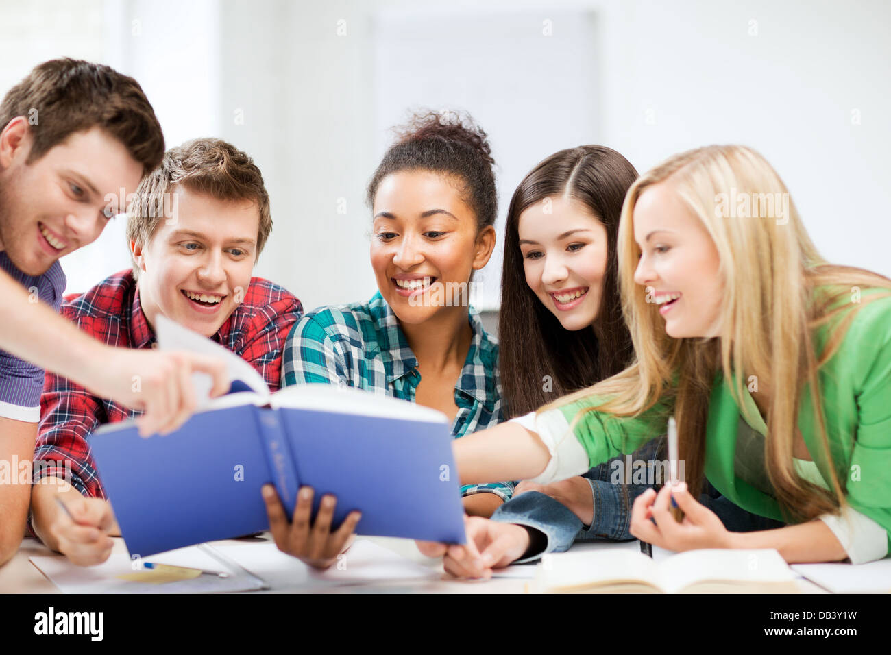 students reading book at school Stock Photo - Alamy