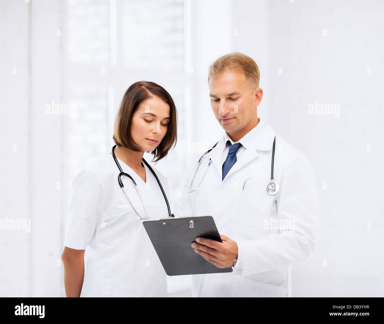 two doctors writing prescription Stock Photo - Alamy