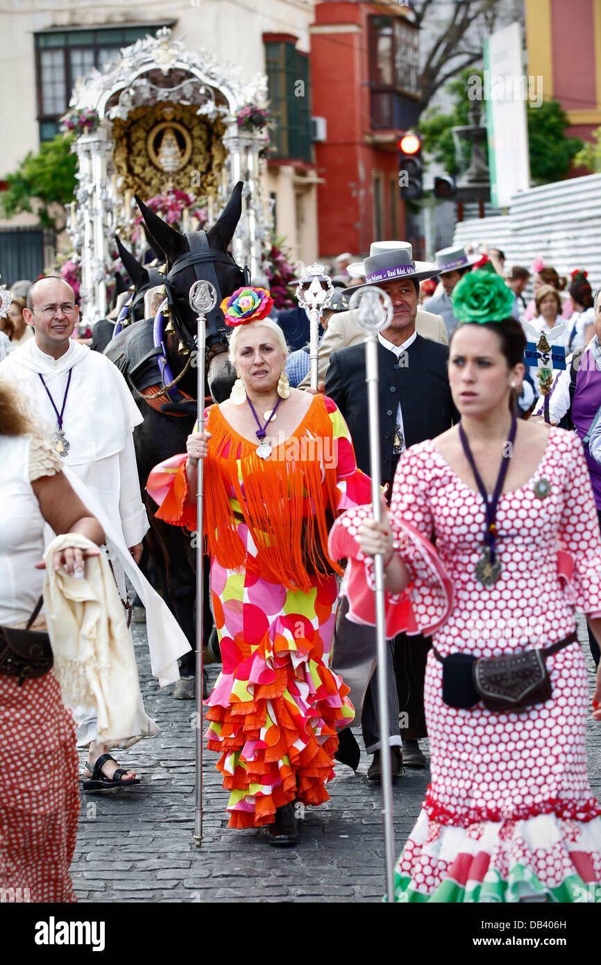 Spanish women wearing gypsy flamenco dresses making the Catholic ...
