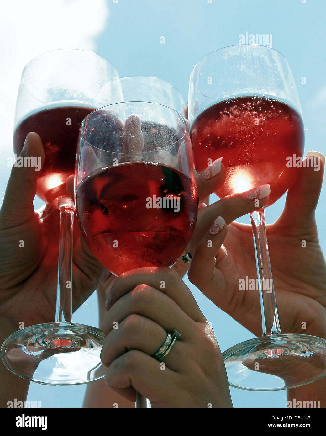Toasting with glasses of red wine Stock Photo - Alamy