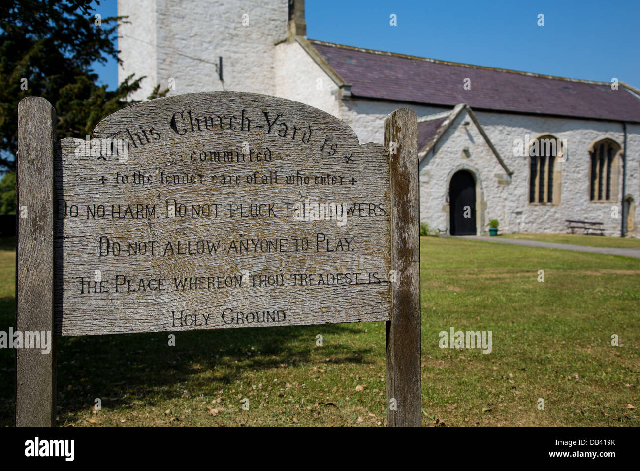 Warning sign on how to behave in a church yard at Interior of he white ...