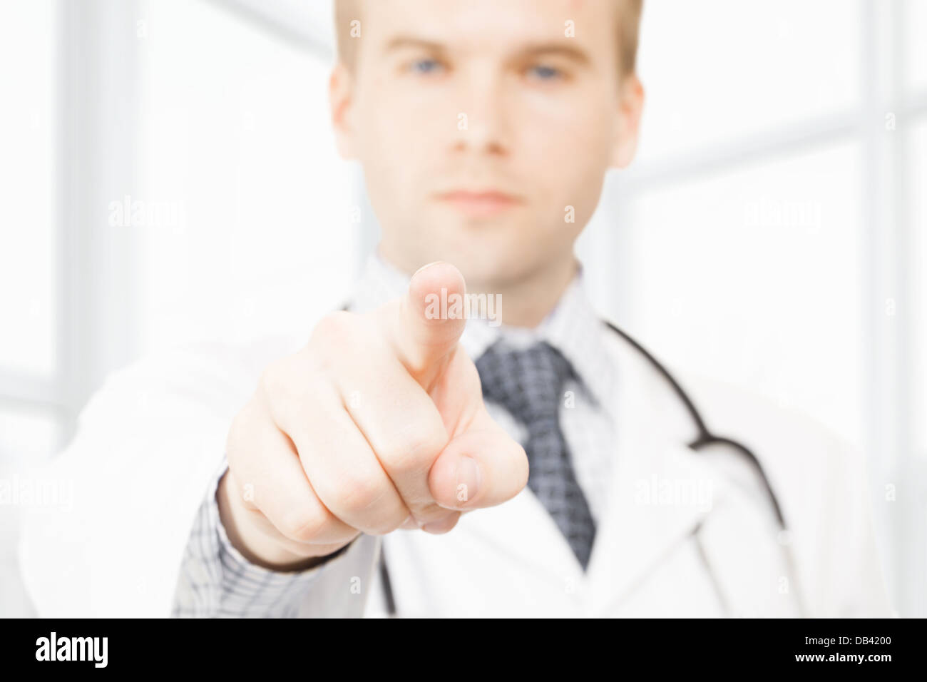 Male doctor pointing his index finger toward viewer Stock Photo - Alamy