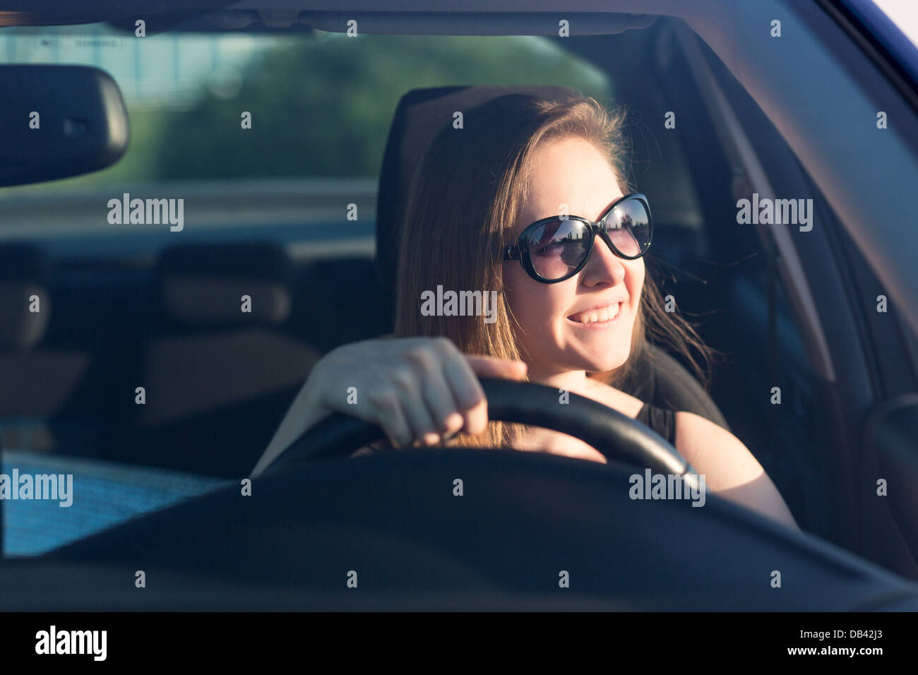 Beautiful businesswoman in sunglasses driving her car Stock Photo - Alamy