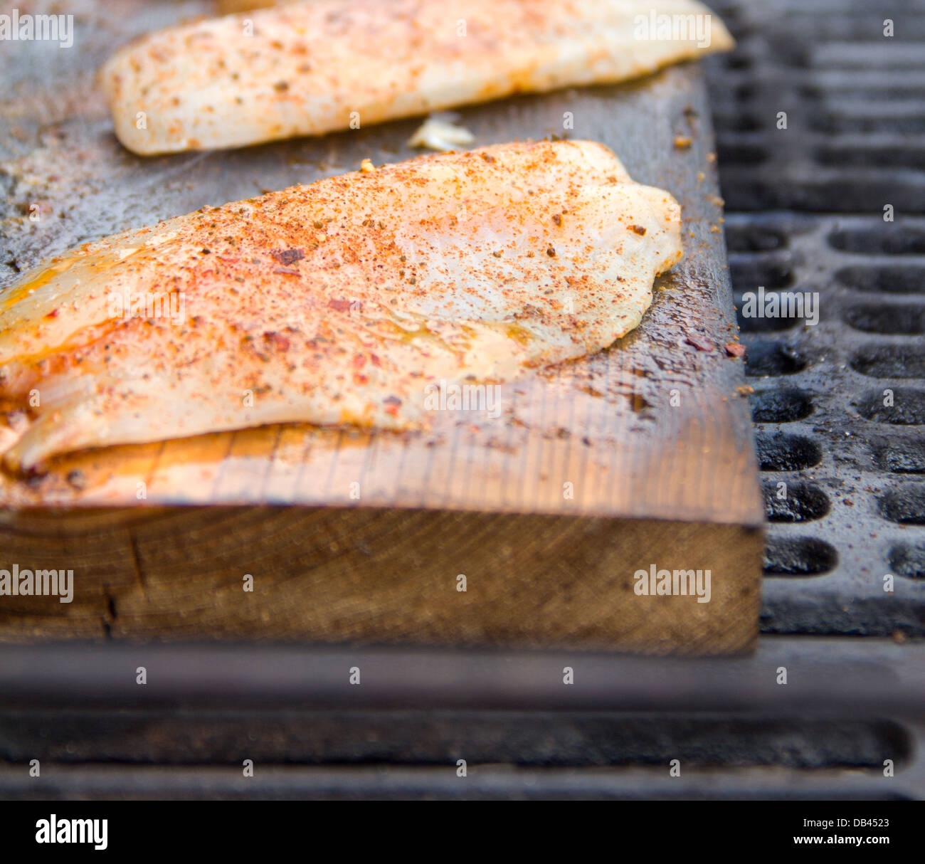 Grilled white fish on a cedar plank Stock Photo - Alamy