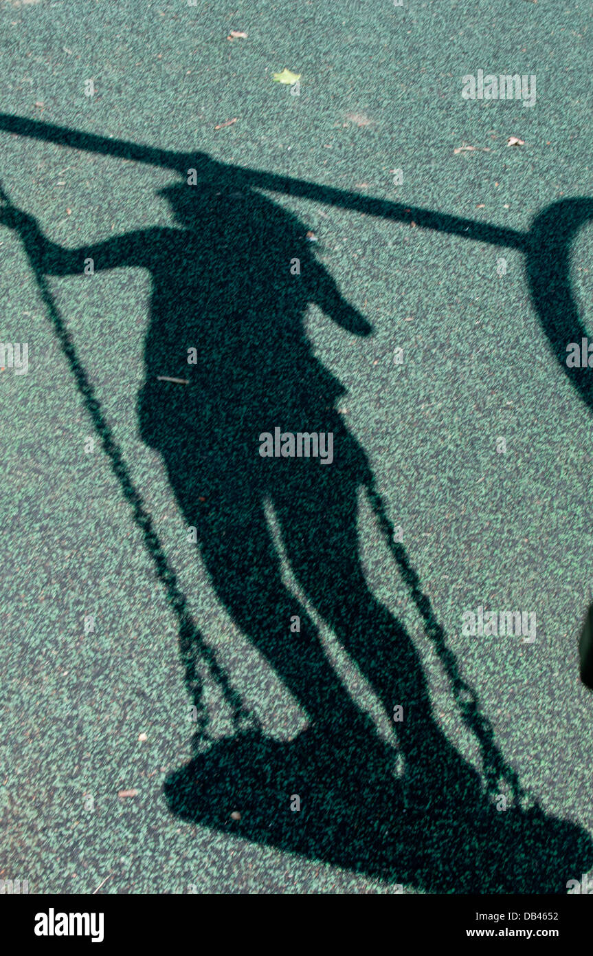 Shadow of girl on a swing Stock Photo - Alamy