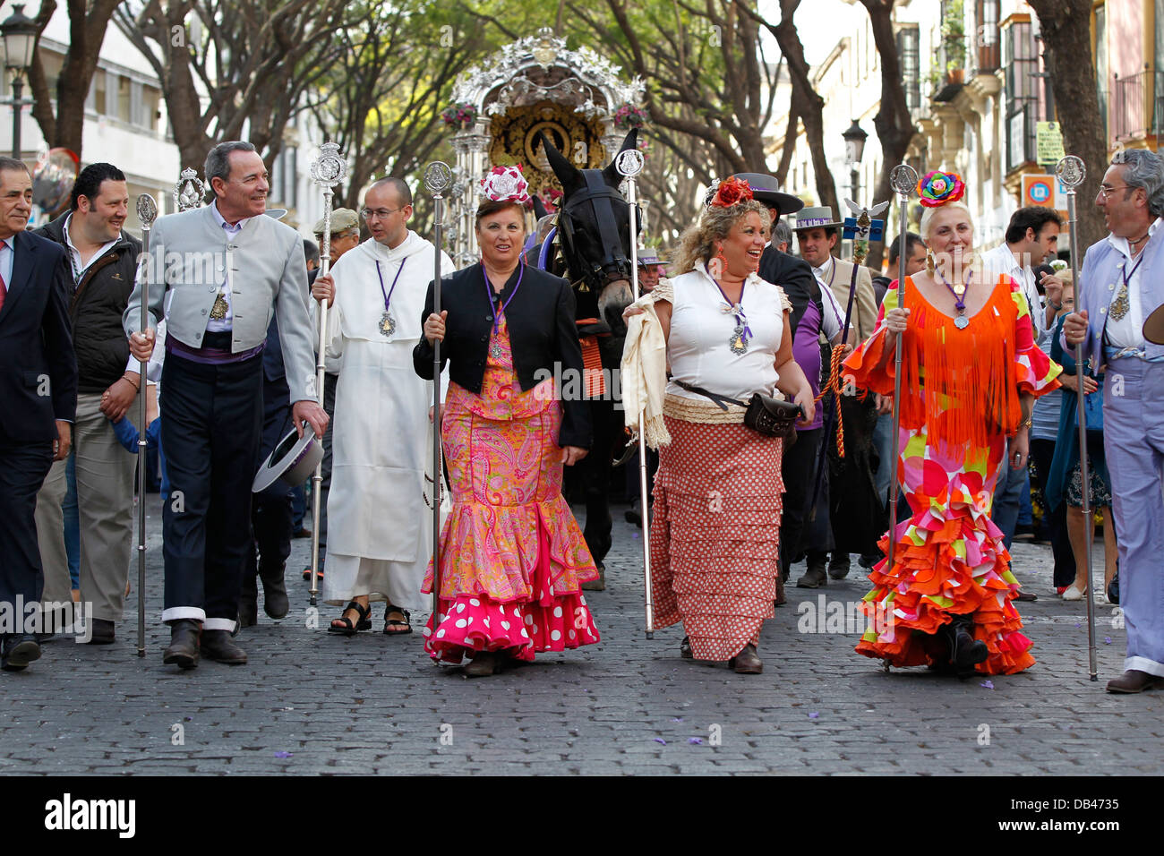 Spanish women wearing gypsy flamenco dresses making the Catholic ...