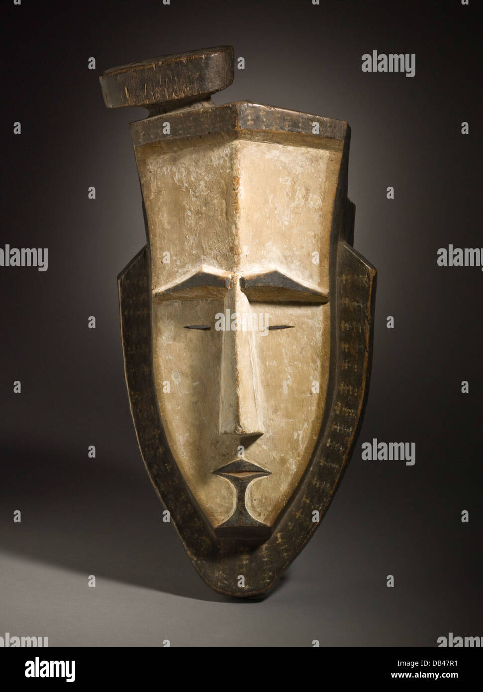 This tapuanu mask, originating from Polynesian cultures, is carved from ...