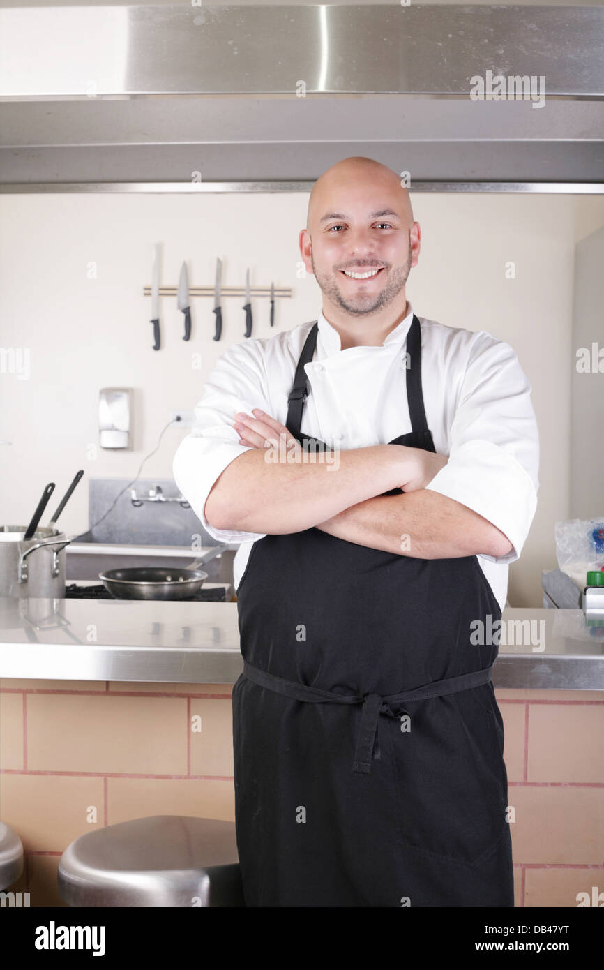 Portrait of young male chef in commercial kitchen Stock Photo - Alamy