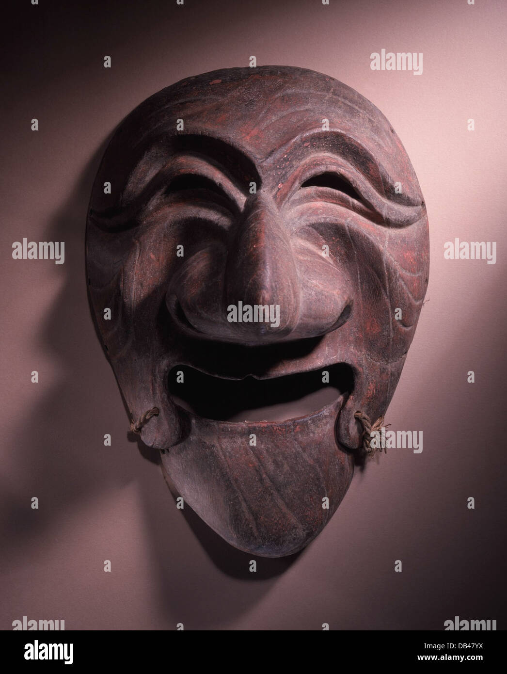 This mask is crafted from bronze and features a detailed, sculptural ...