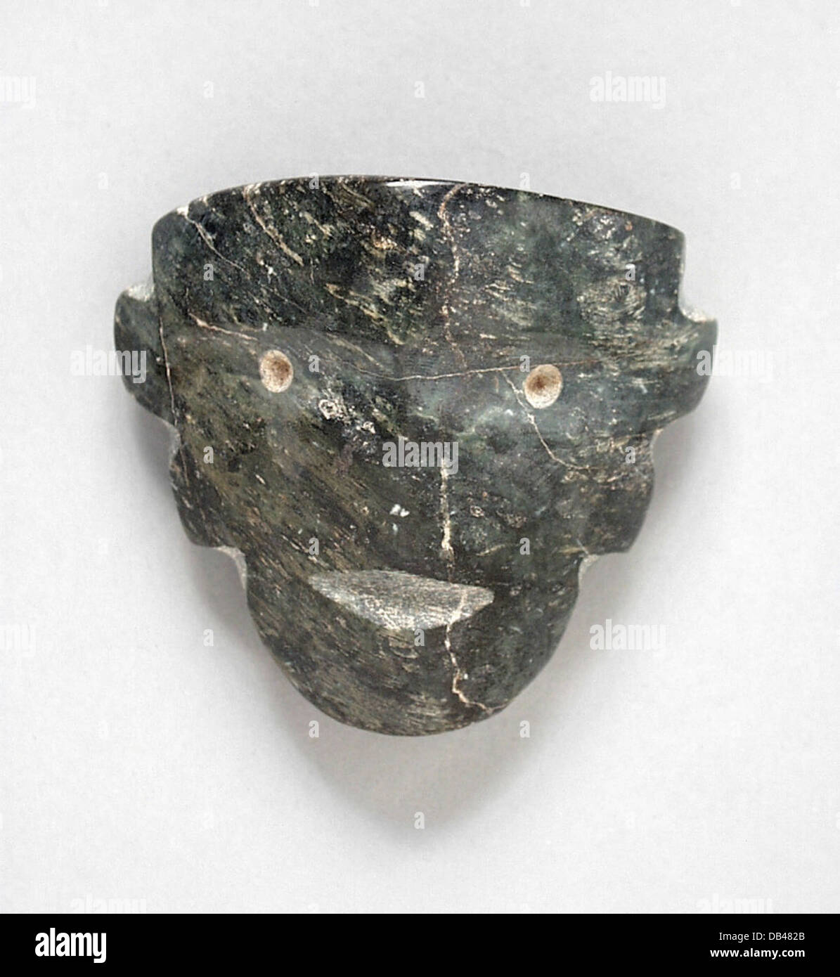 This mask is a cast bronze object, representing cultural traditions ...