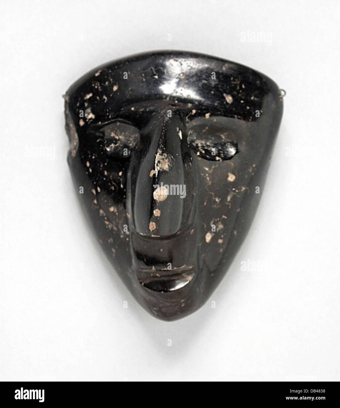 This mask is a ritualistic artifact, likely used in ceremonial ...