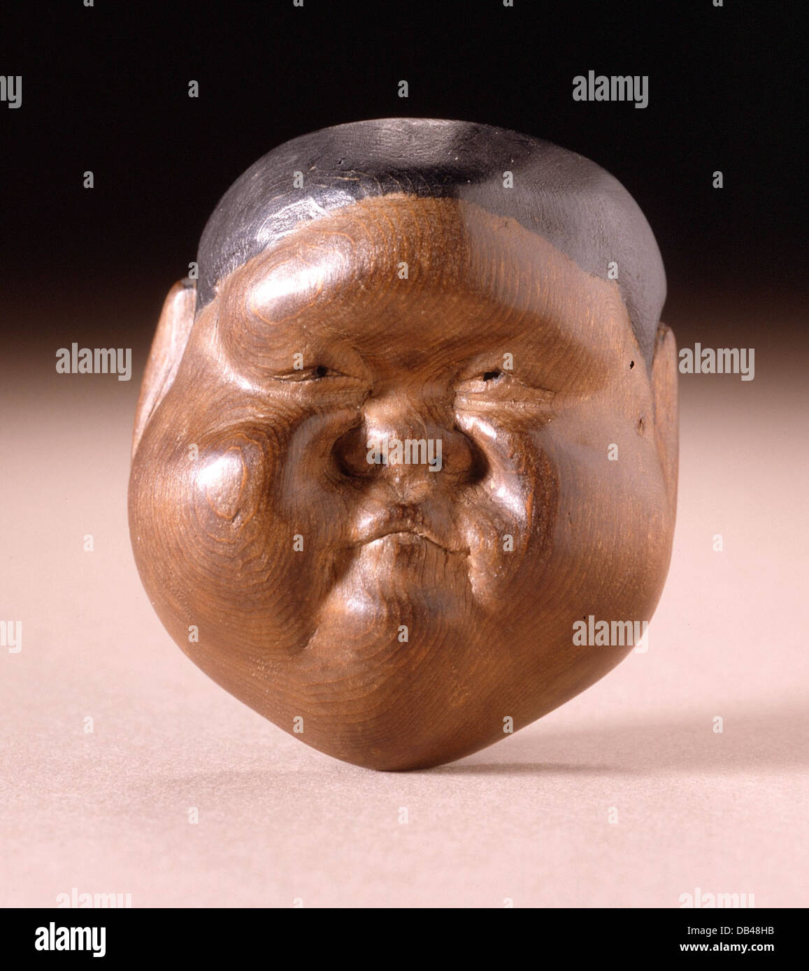 This mask represents a sumo wrestler's face, designed for theatrical or ...