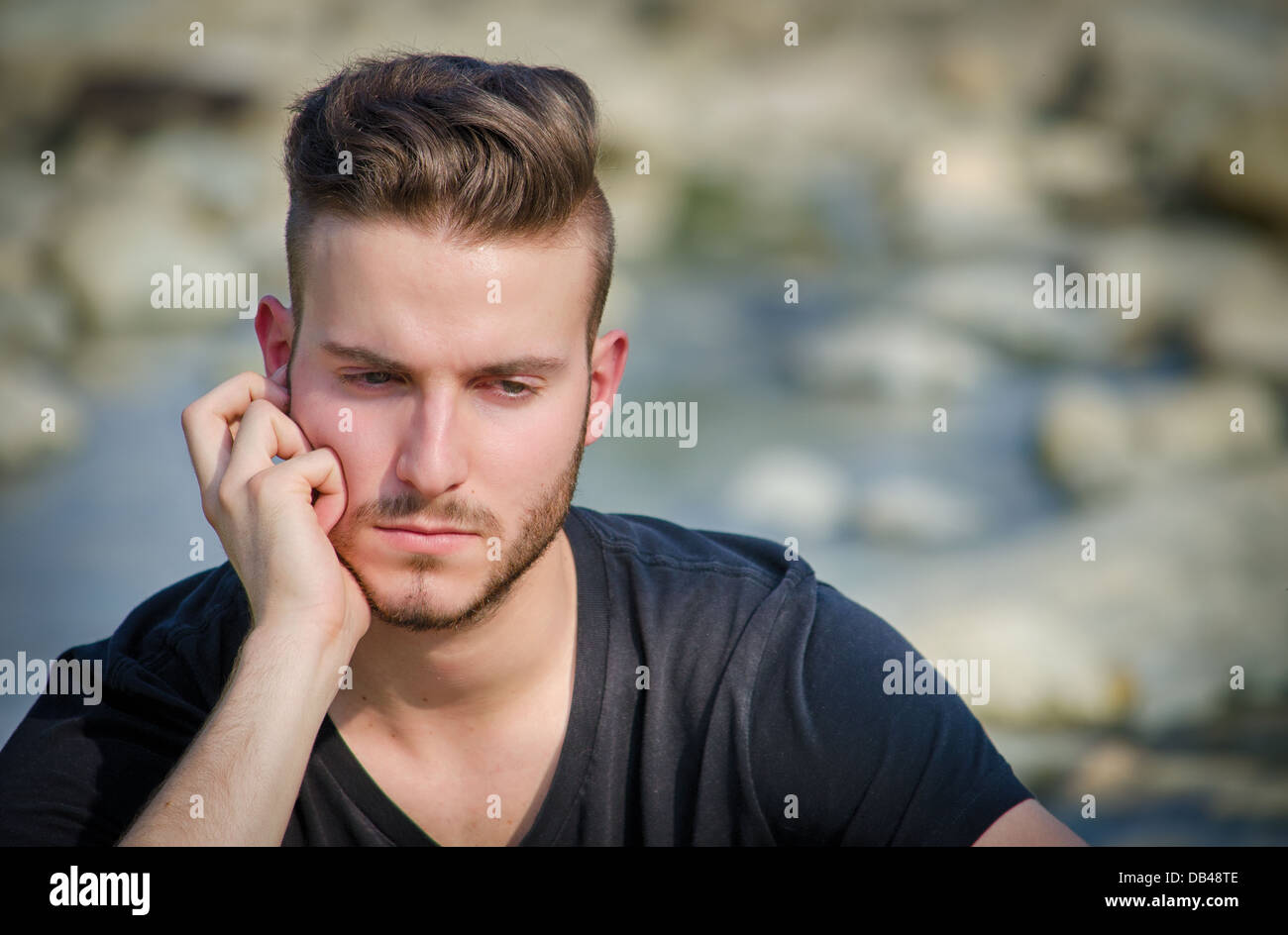 Portrait of sad, worried or depressed young man outdoors thinking Stock ...