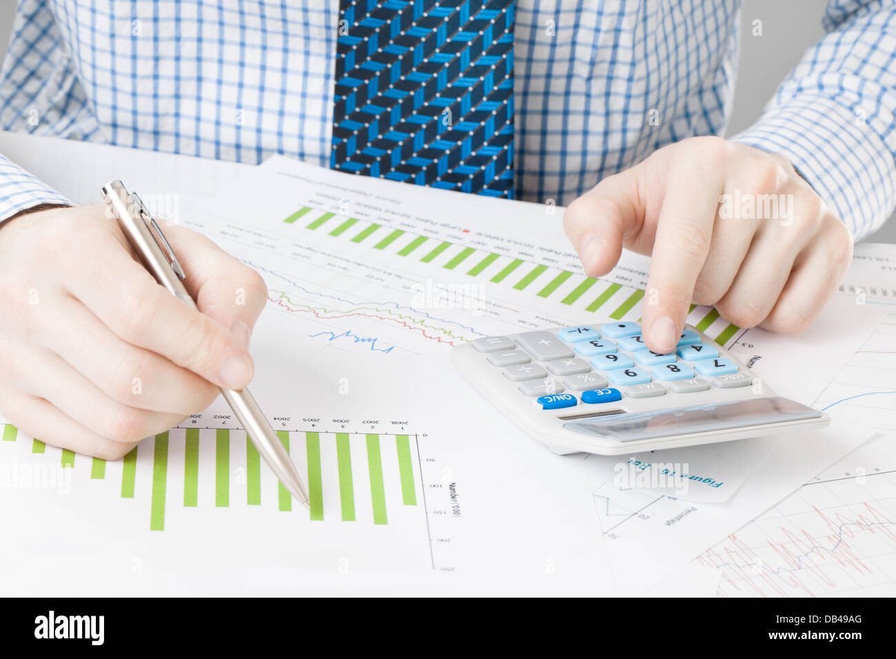 Business man busy with calculating something at the desk Stock Photo ...