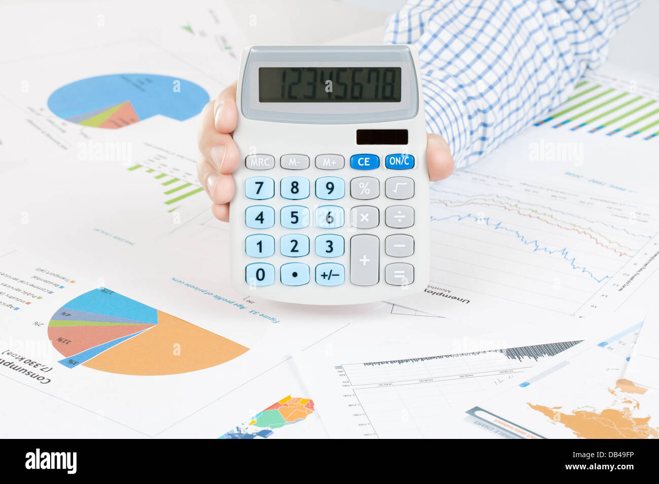 Business man holding calculator in his right hand Stock Photo - Alamy