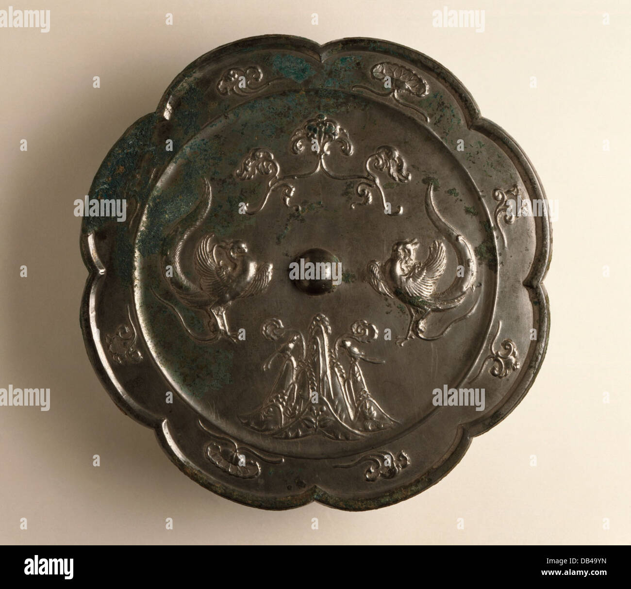 This ancient Chinese mirror (Jing) is adorned with intricate motifs of ...
