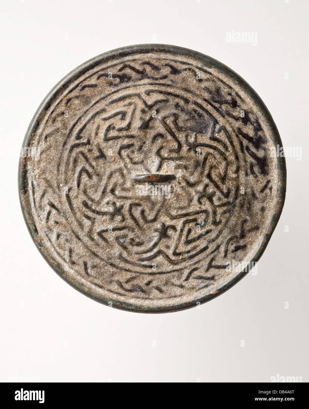 This ancient mirror, often used for personal grooming, features a ...