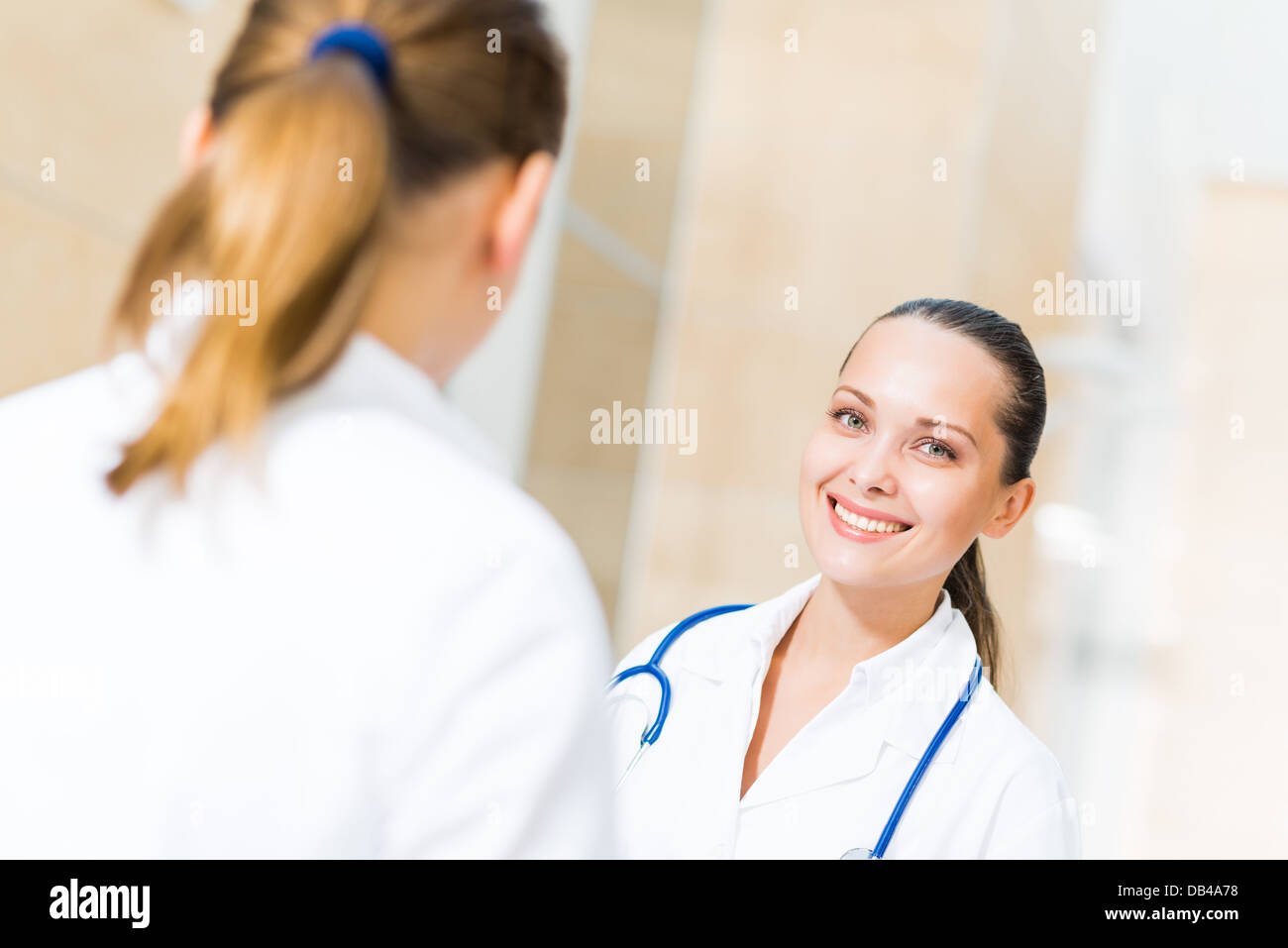 two doctors talking in the lobby Stock Photo - Alamy