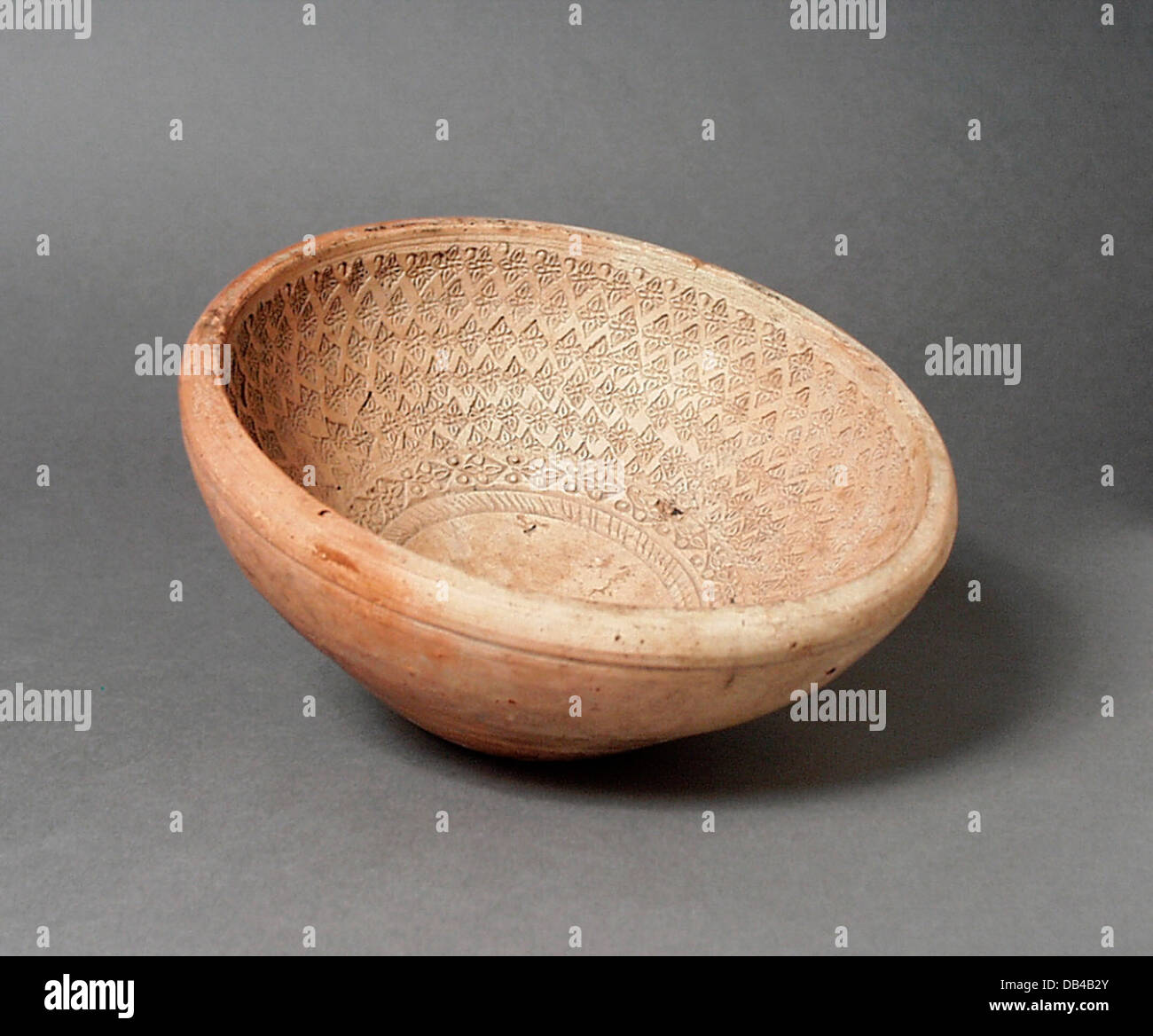 This ancient mold, used for creating shaped objects, demonstrates the ...