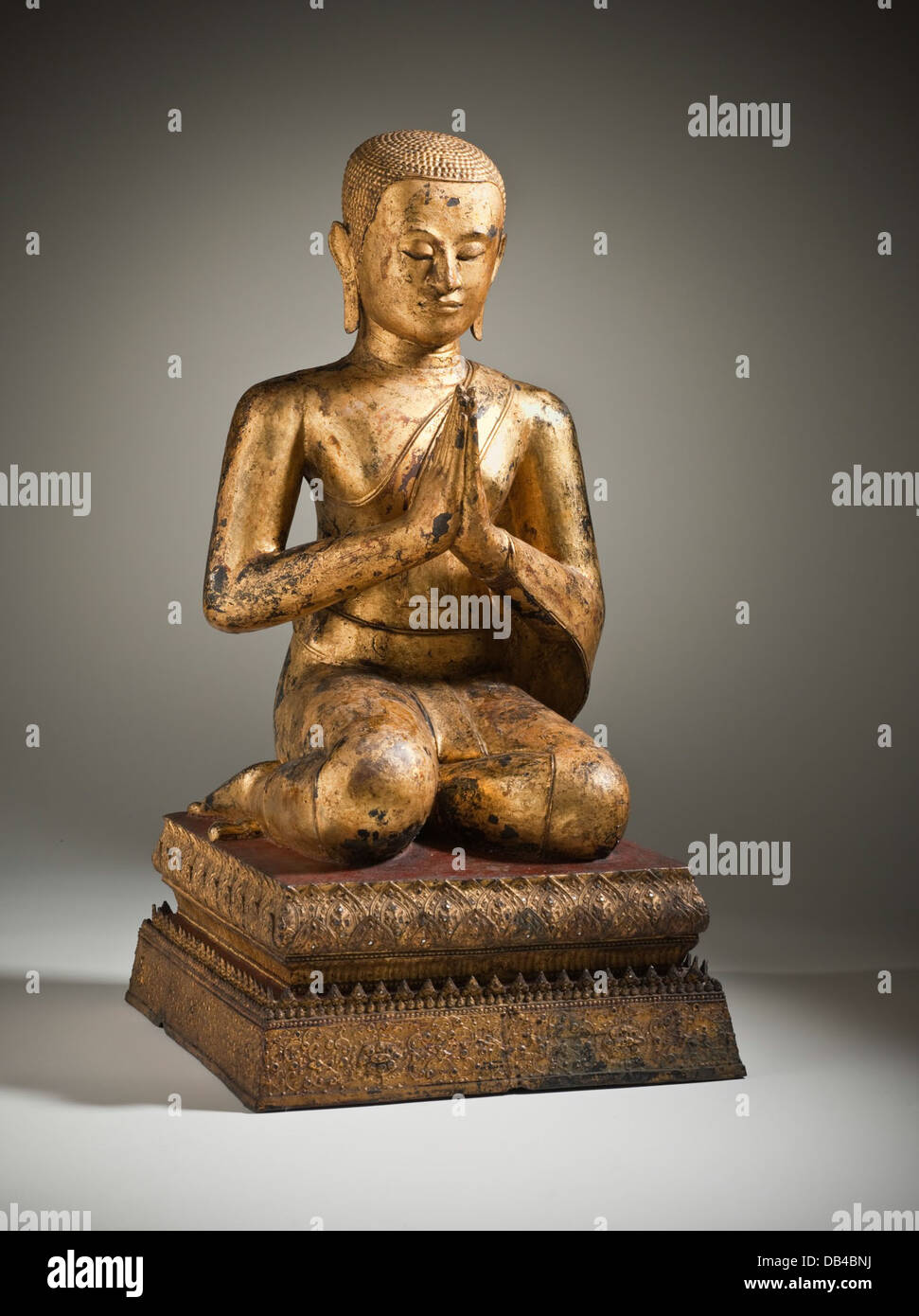 A sculpture of a monk devotee, showcasing religious devotion through ...