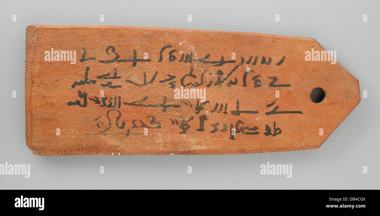 This mummy label features Demotic inscriptions on both sides, offering ...