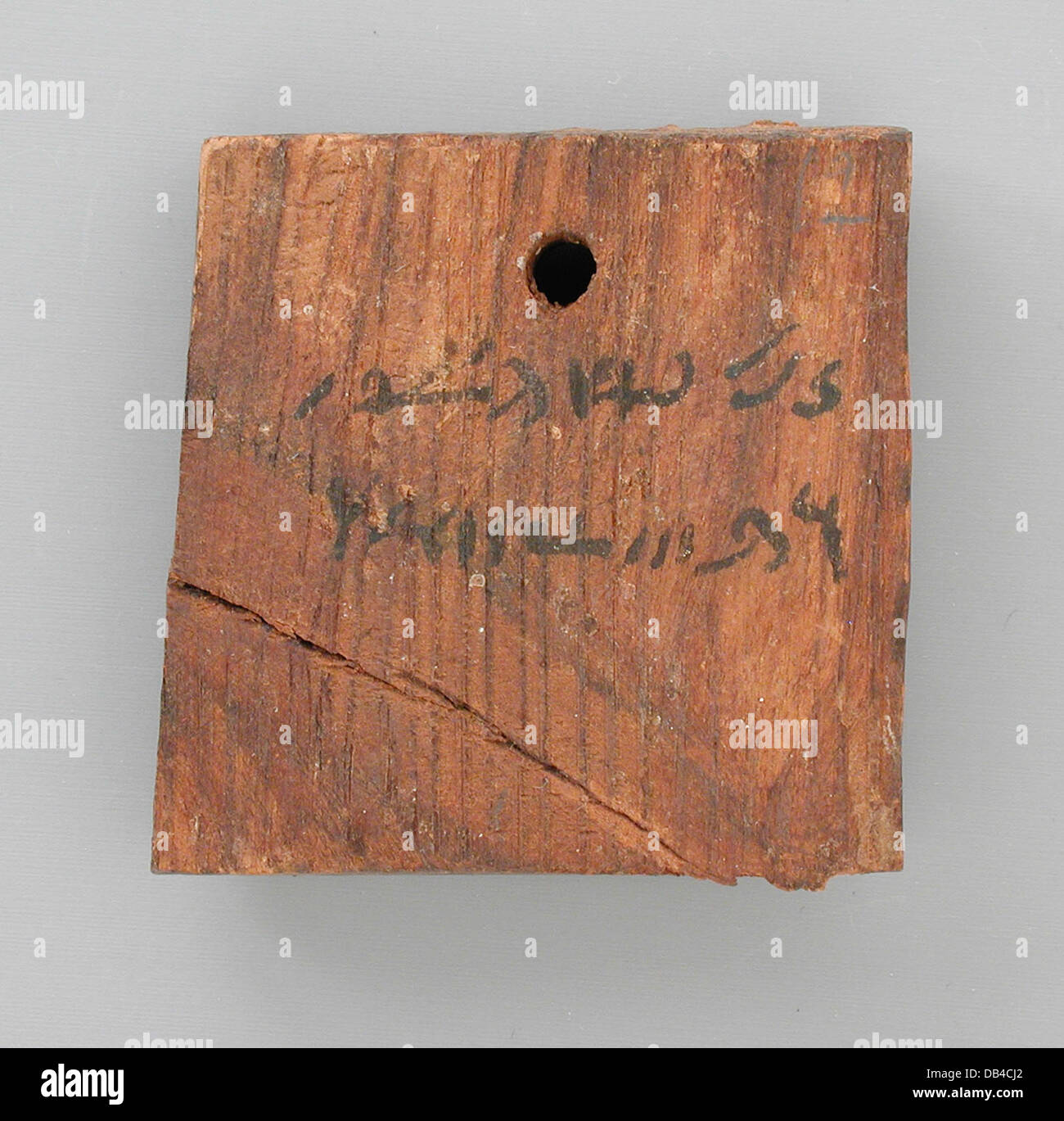 This mummy label features a demotic inscription, likely identifying the ...