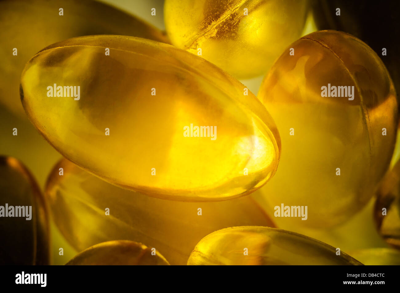 Golden colored fish oil capsules Close up Stock Photo - Alamy