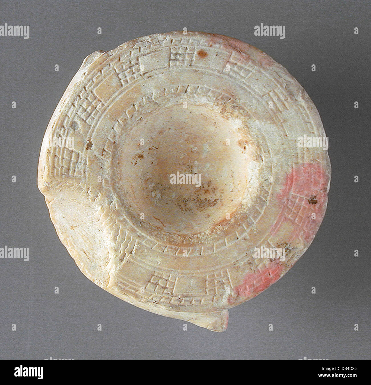 This oil lamp, crafted from ceramic, was historically used for lighting ...