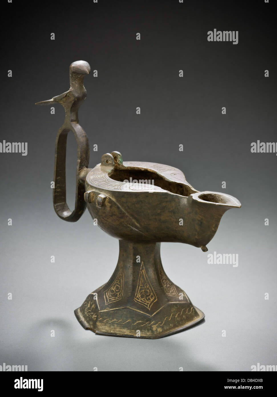This ancient oil lamp, crafted from ceramic, features a functional ...