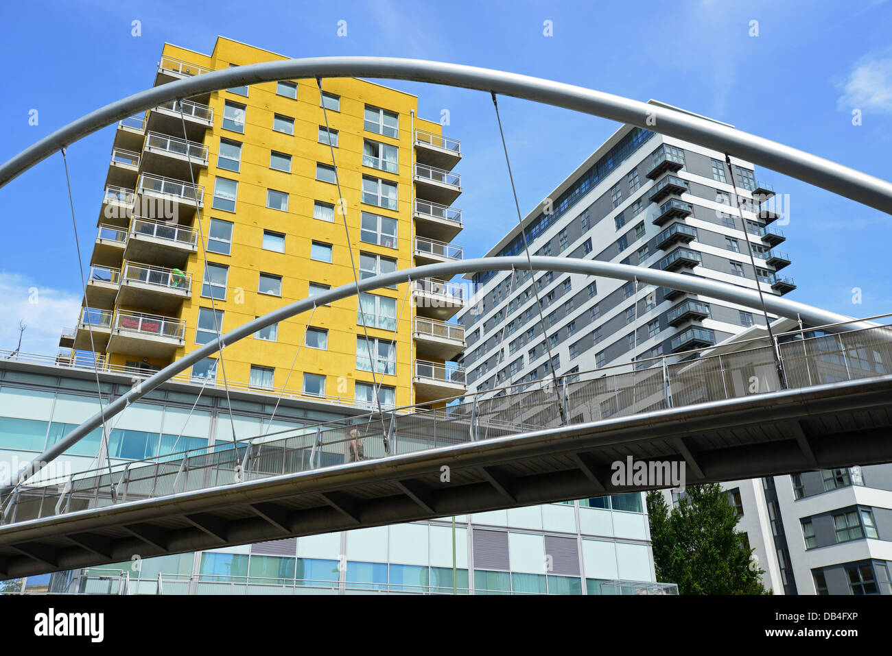 Pedestrian flyover foot bridge with high-rise apartments behind ...