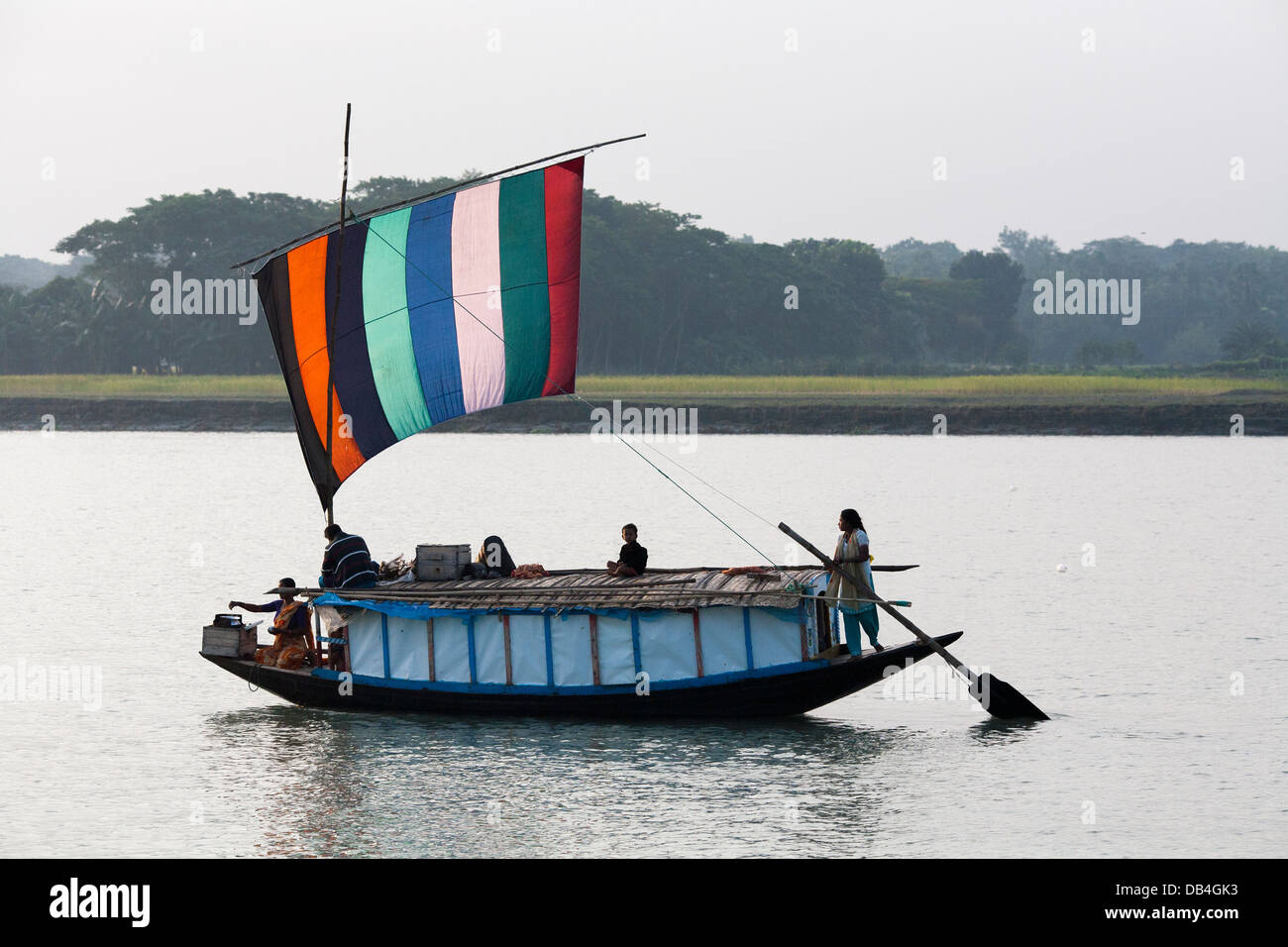 A family live a nomadic life on the rivers of Bangladesh on a traditional sail boat. A woman ...